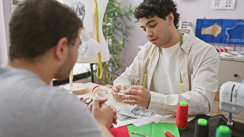 Two Men Collaborating in a Tailor Shop, with Sewing Equipment and ...