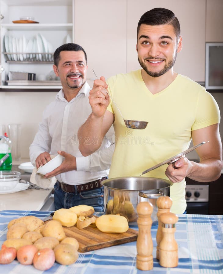 Two men cooking at home stock photo. Image of chopping - 60368856