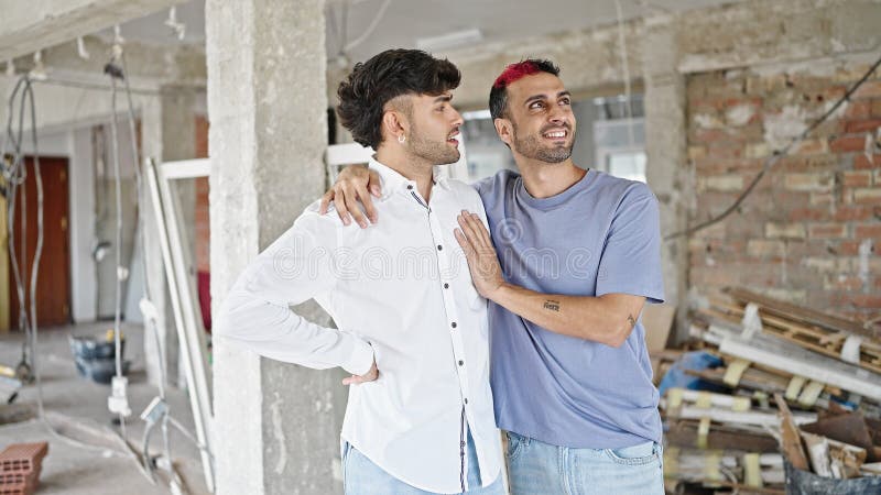 Two Men Couple Hugging Each Other Looking Around at Construction Site ...