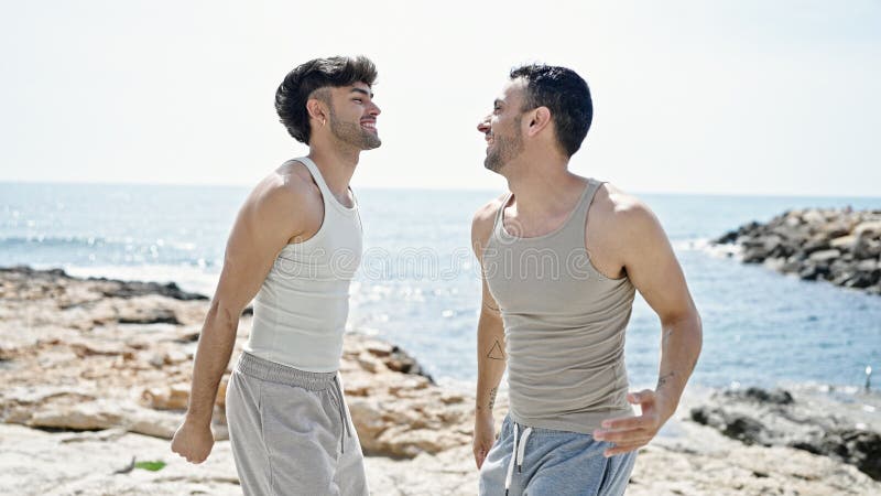 Two Men Couple Smiling Confident Dancing at Seaside Stock Image - Image ...