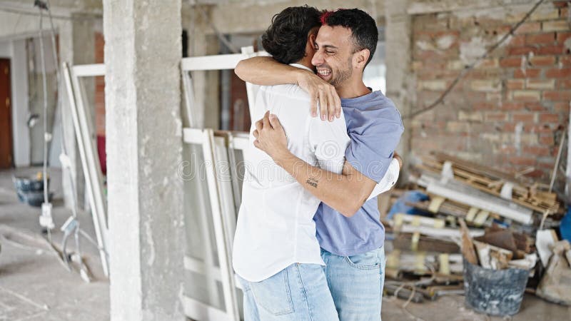 Two Men Couple Smiling Confident Hugging Each Other at Construction ...