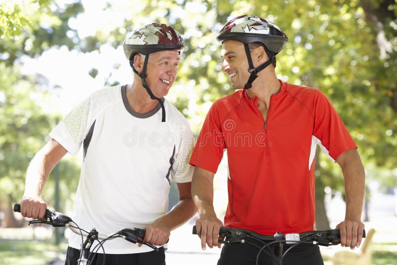 Two Men Cycling through Park Stock Photo - Image of happy, safety: 54962138