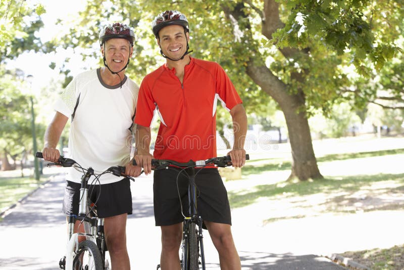 Two Men Cycling through Park Stock Photo - Image of helmet, healthy ...