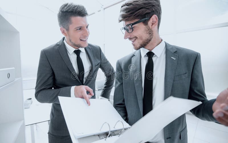Two Men Discuss Information in a Folder with Documents Stock Image ...
