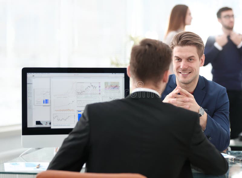 Two Men Discuss the Growth of the Company, Looking at the Rising Graph ...