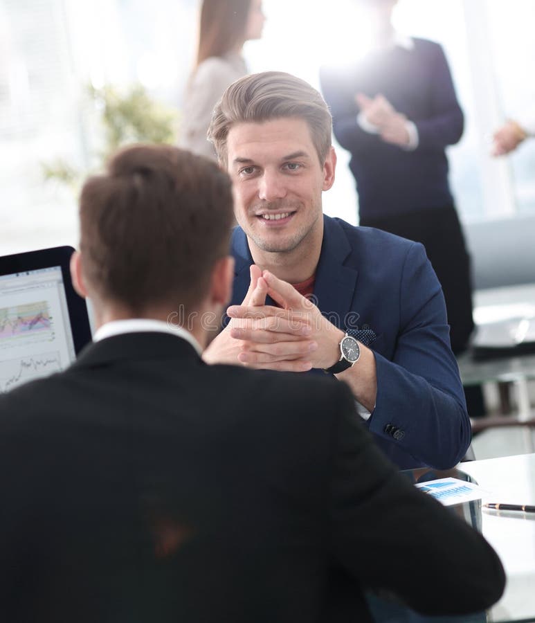Two Men Discuss the Growth of the Company, Looking at the Rising Graph ...