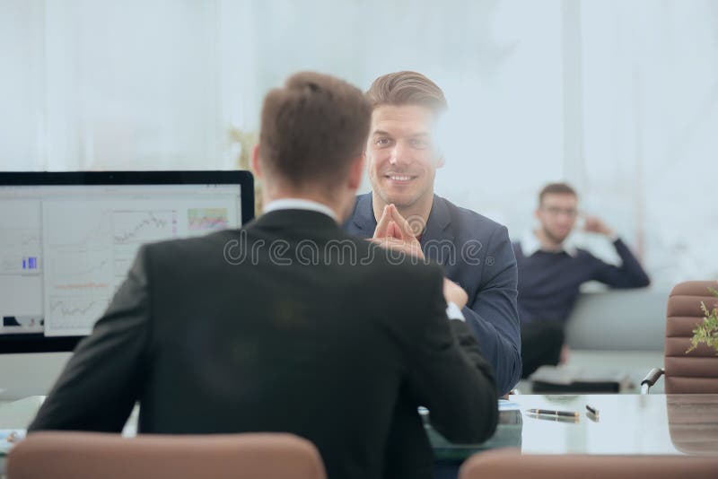 Two Men Discuss the Growth of the Company, Looking at the Rising Graph ...