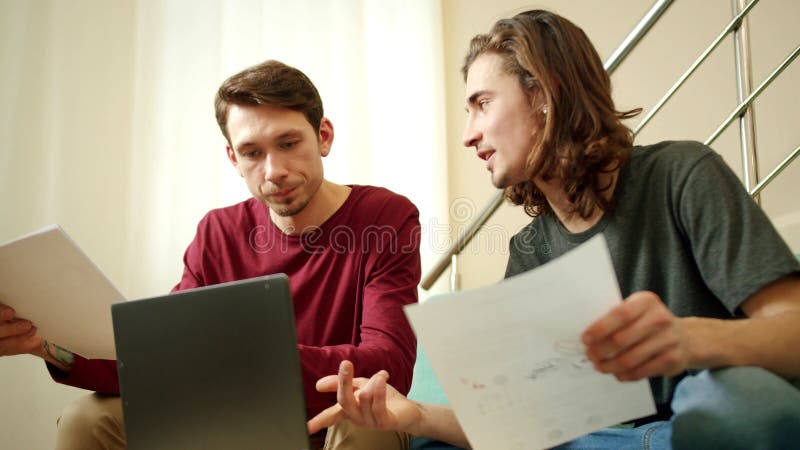 Two Men are Discussing and Looking through Documents Stock Photo ...