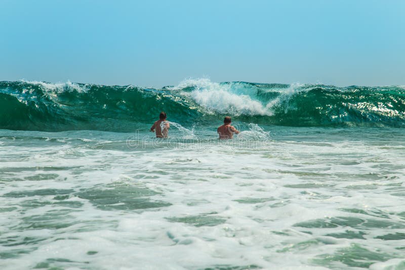 Two Men Dive into the Waves. Stock Image - Image of beautiful, dive ...