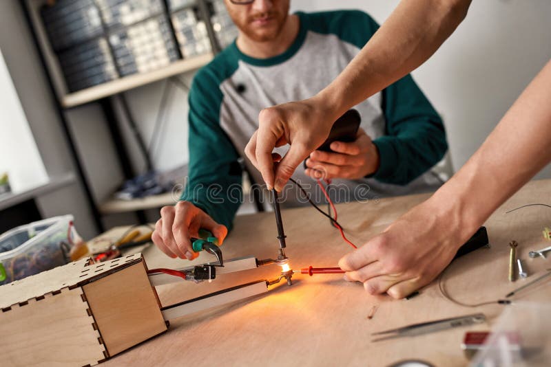 Two Men Do Experiment with Forceps and Voltmeter Stock Image - Image of ...