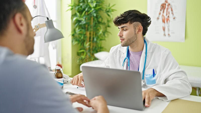 Two Men Doctor and Patient Using Laptop Having Consultation at Clinic ...