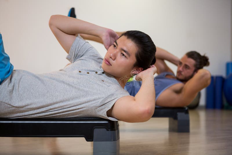 Two Men Doing Aerobic Exercise on Stepper Stock Image - Image of ...