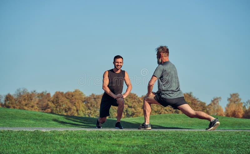 The Two Men Doing Exercise Outdoor. Stock Photo - Image of nature ...