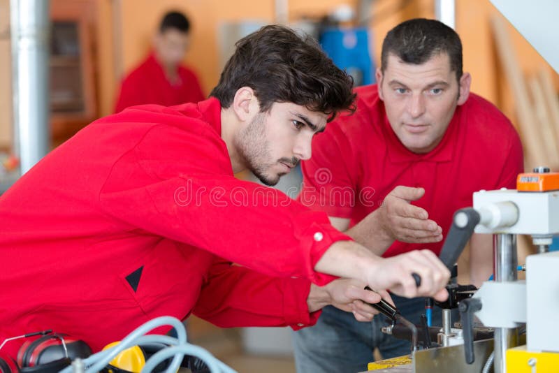 Two men doing factory work stock image. Image of crank - 206331689