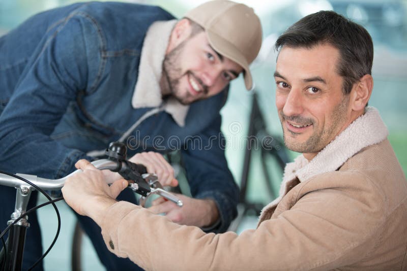 Two Men Doing Mechanical Work on Bicycle Stock Photo - Image of service ...