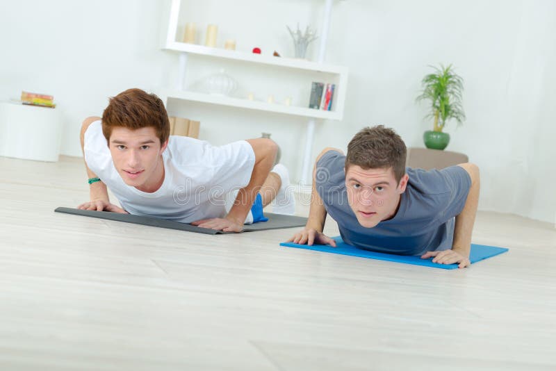 Two men doing push-ups stock image. Image of healthy - 205858743