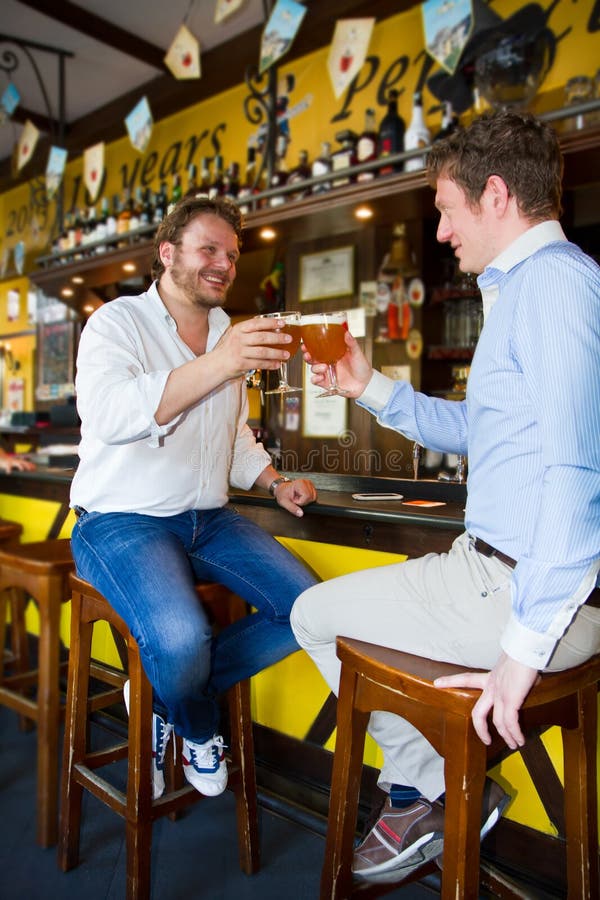Two Men Drinking Beer in Bar Stock Image - Image of group, drinking ...