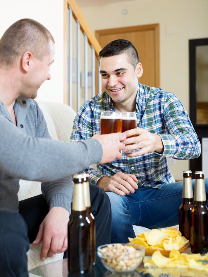 Two men drinking beer stock image. Image of faces, discussion - 74595541