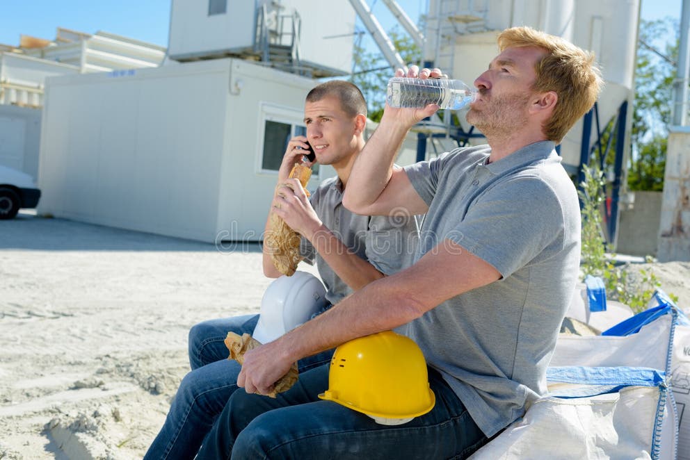 Two Men Eating Their Lunch on Construction Site Stock Photo - Image of ...