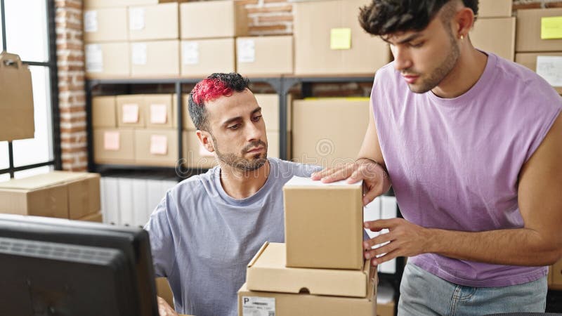 Two Men Ecommerce Business Workers Using Computer Holding Packages at ...