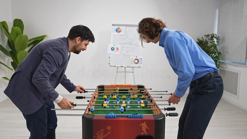 Two Men Engaged in Office Foosball Game during Break Stock Image ...