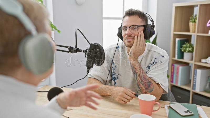 Two Men Engaged in a Relaxed Podcast Interview in a Modern Studio ...