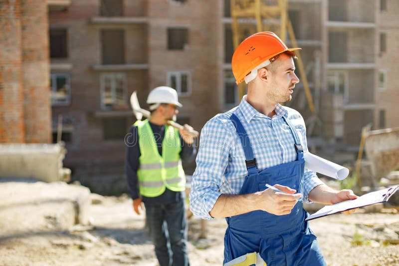 Two Men Engineers at a Construction Site Doing Their Job Stock Image ...