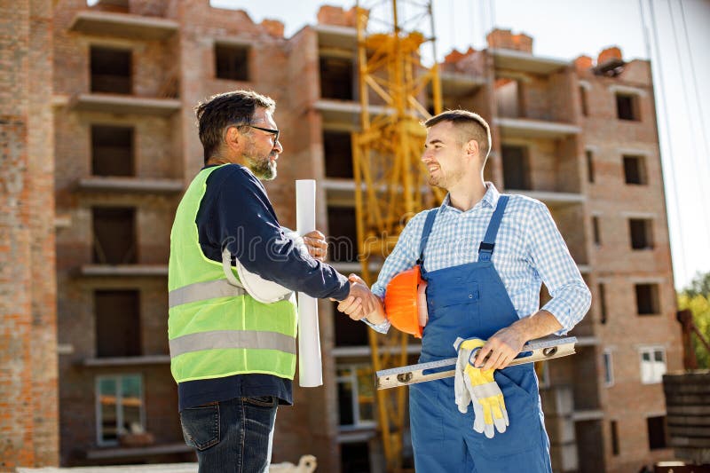 Two Men Engineers at a Construction Site Shaking Hands Stock Photo ...