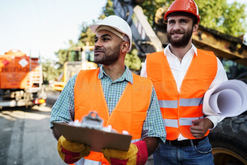 Two Men Engineers Discussing Their Work Standing Against Construction ...