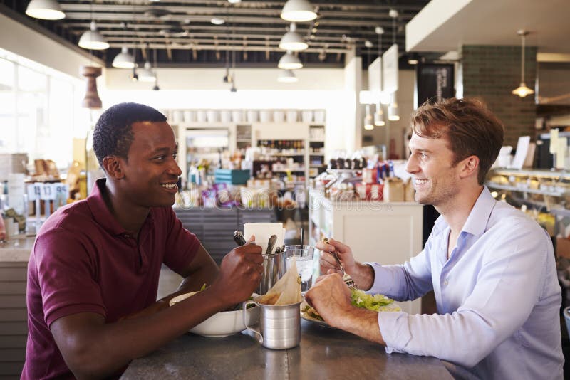 Two Men Enjoying Lunch in Delicatessen Restaurant Stock Image - Image ...