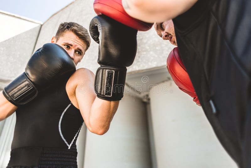 Two Men Exercising and Fighting in Outside. Boxer in Gloves is Training ...