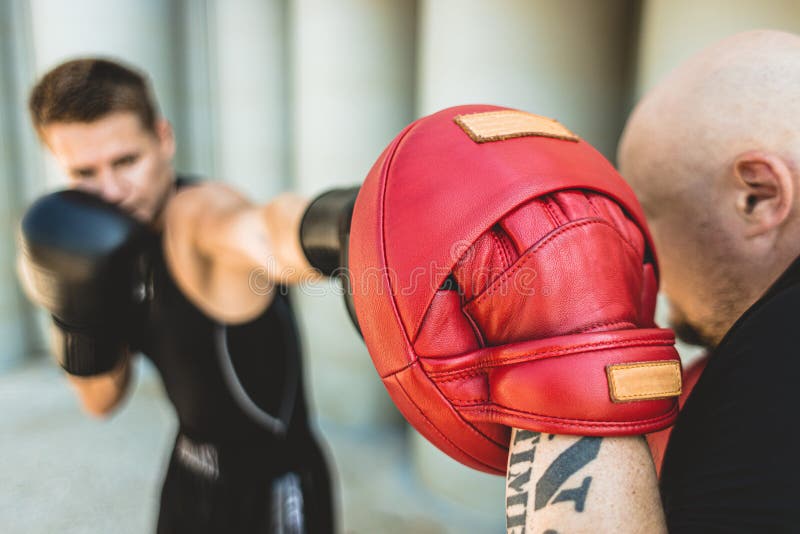 Two Men Exercising and Fighting in Outside. Boxer in Gloves is Training ...