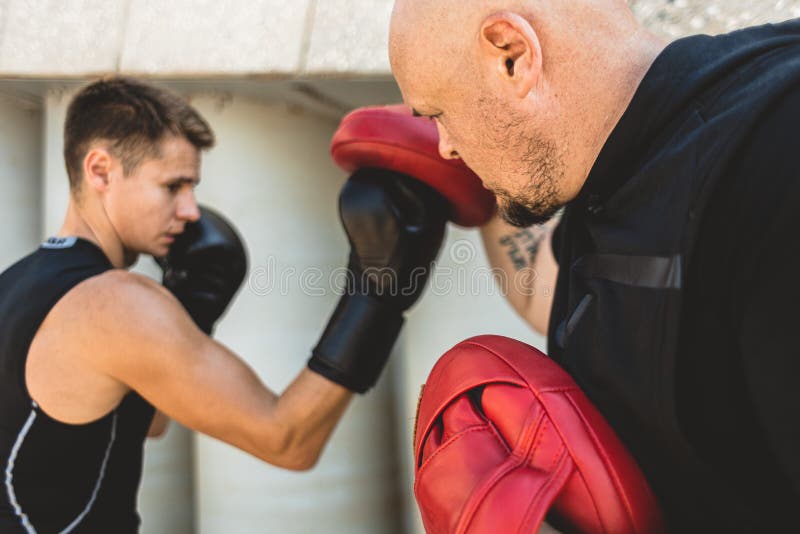 Two Men Exercising and Fighting in Outside. Boxer in Gloves is Training ...