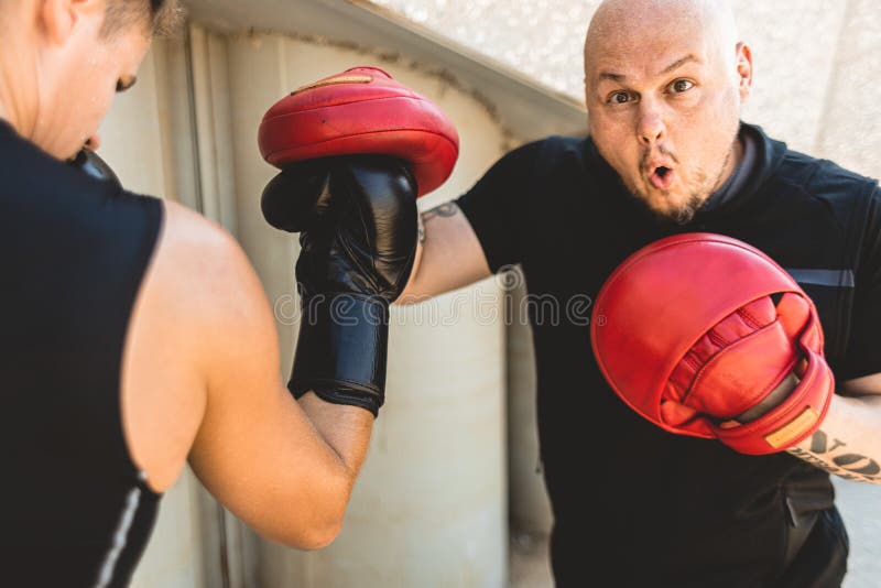 Two Men Exercising and Fighting in Outside. Boxer in Gloves is Training ...