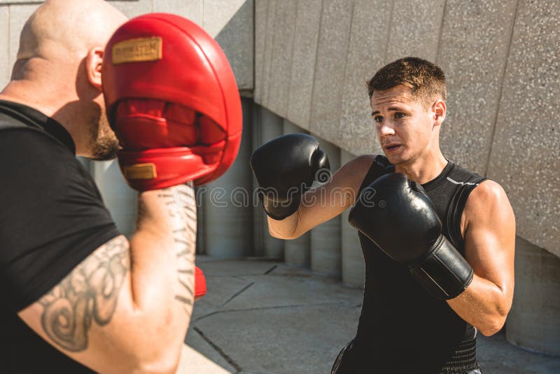 Two Men Exercising and Fighting in Outside. Boxer in Gloves is Training ...
