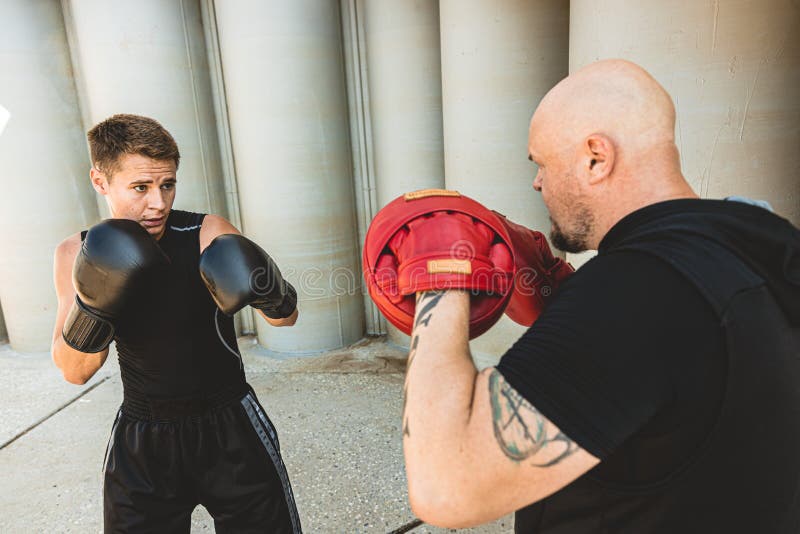 Two Men Exercising and Fighting in Outside. Boxer in Gloves is Training ...