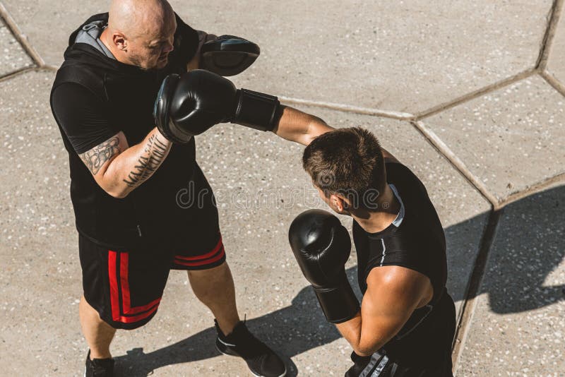 Two Men Exercising and Fighting in Outside. Boxer in Gloves is Training ...