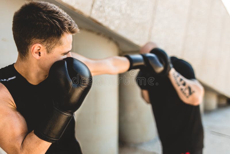 Two Men Exercising and Fighting in Outside. Boxer in Gloves is Training ...