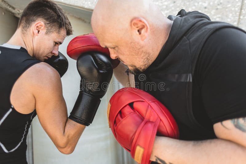 Two Men Exercising and Fighting in Outside. Boxer in Gloves is Training ...