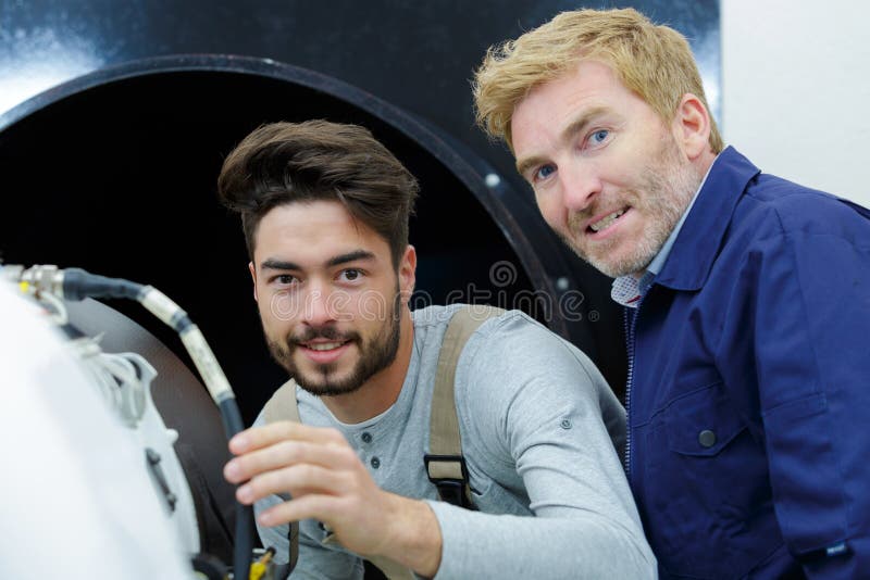 Two Men in Factory Operating Modern Machines Stock Image - Image of ...