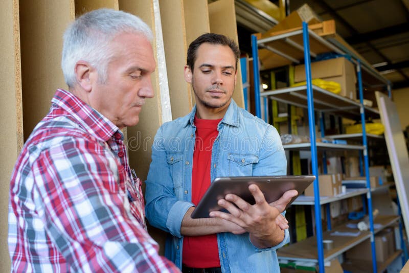 Two Men in Factory Stores Looking at Tablet Computer Stock Image ...