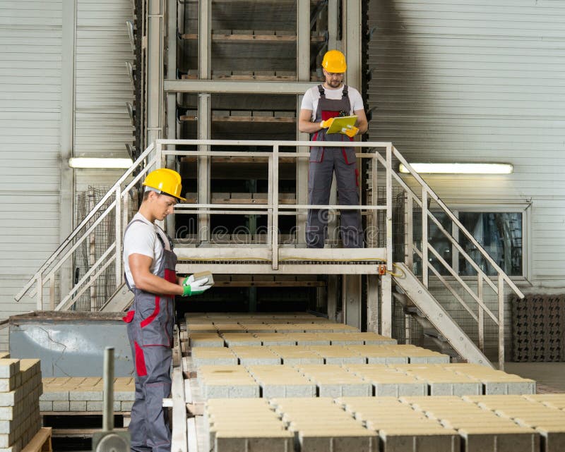 Two men on a factory stock photo. Image of kerbstone - 40984436