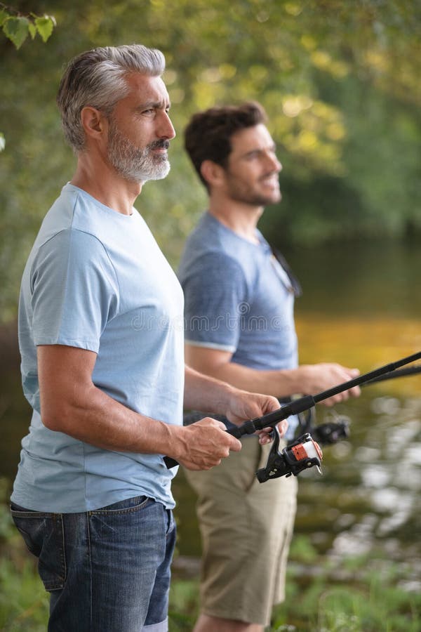 Two Men Fishing from Pier on River Stock Image - Image of rowboat, rest ...