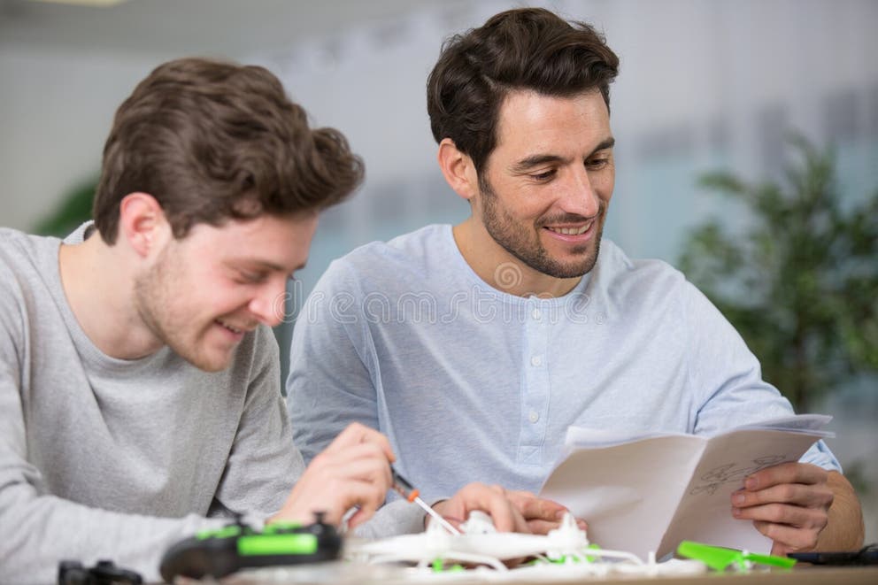 Two men fixing drone stock image. Image of male, soldering - 288845681