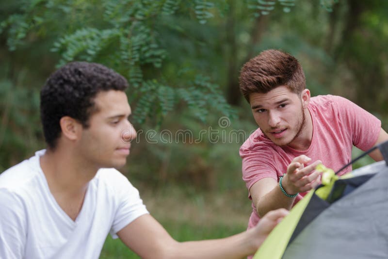 Two men fixing tent stock photo. Image of sitting, freedom - 235015710