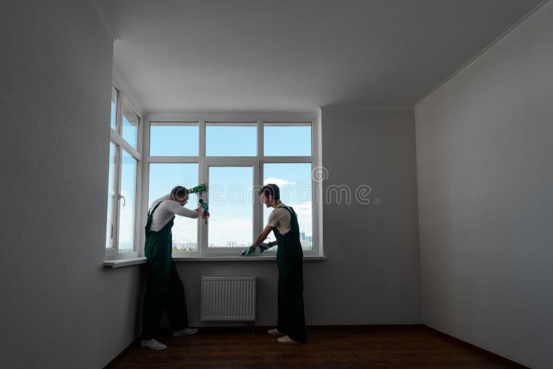 Two men are fixing window stock photo. Image of plastic - 133351594