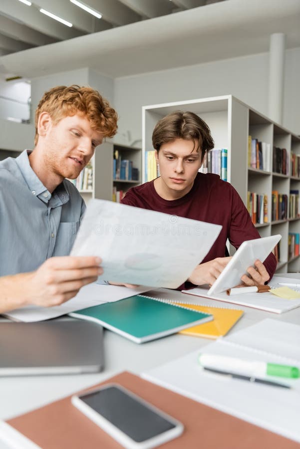 Two Men Focus on Reading Papers Stock Photo - Image of university ...