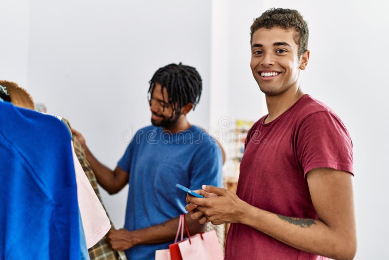 Two Men Friends Choosing Clothes Using Smartphone at Clothing Store ...