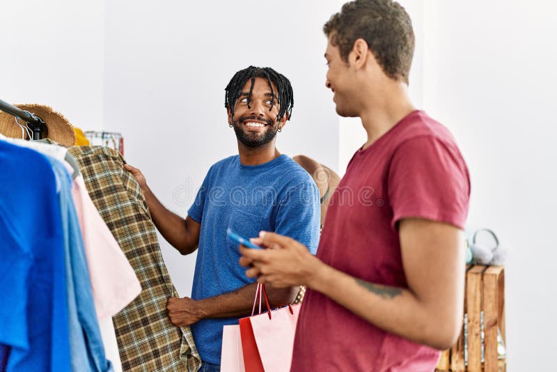 Two Men Friends Choosing Clothes Using Smartphone at Clothing Store ...