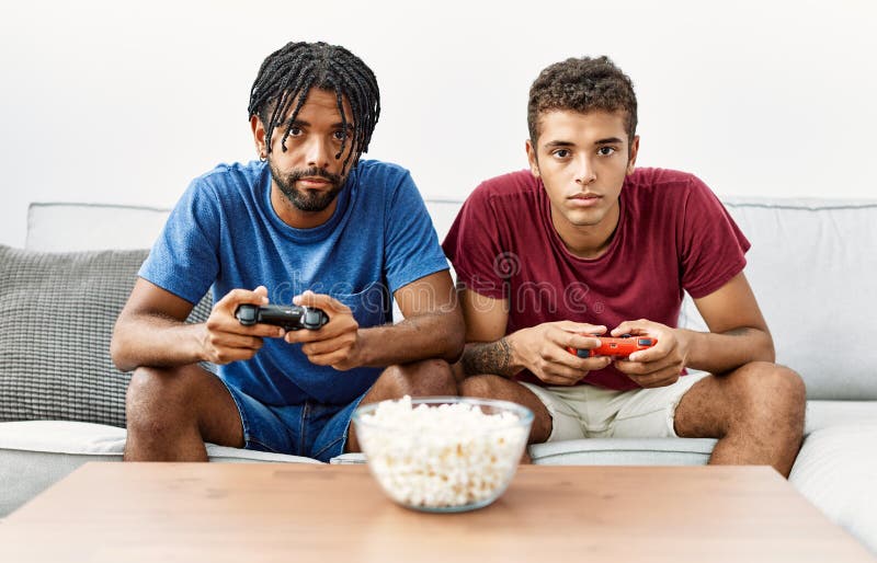Two Men Friends Playing Video Game Sitting on Sofa at Home Stock Photo ...